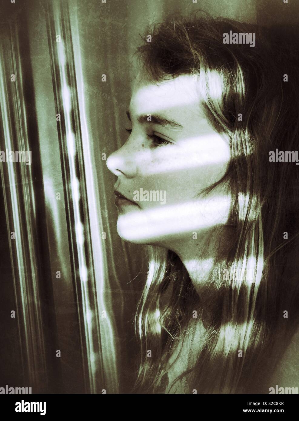 Profile portrait of girl with lines of sunlight on face Stock Photo - Alamy