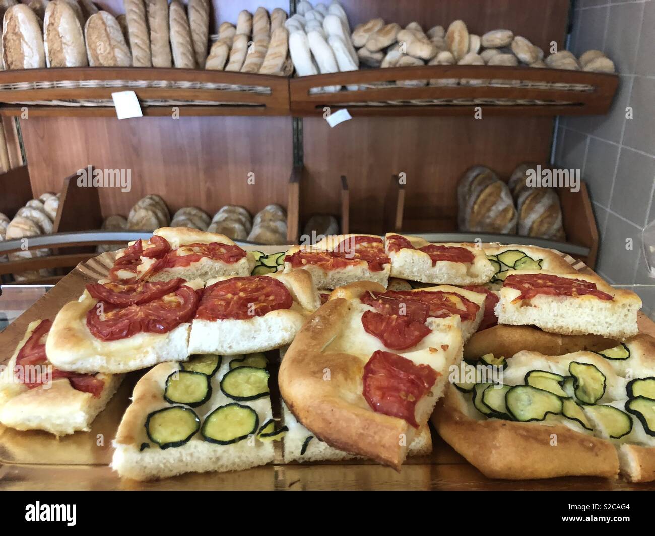 Pizza and breads exposed in a bio bakery Stock Photo - Alamy