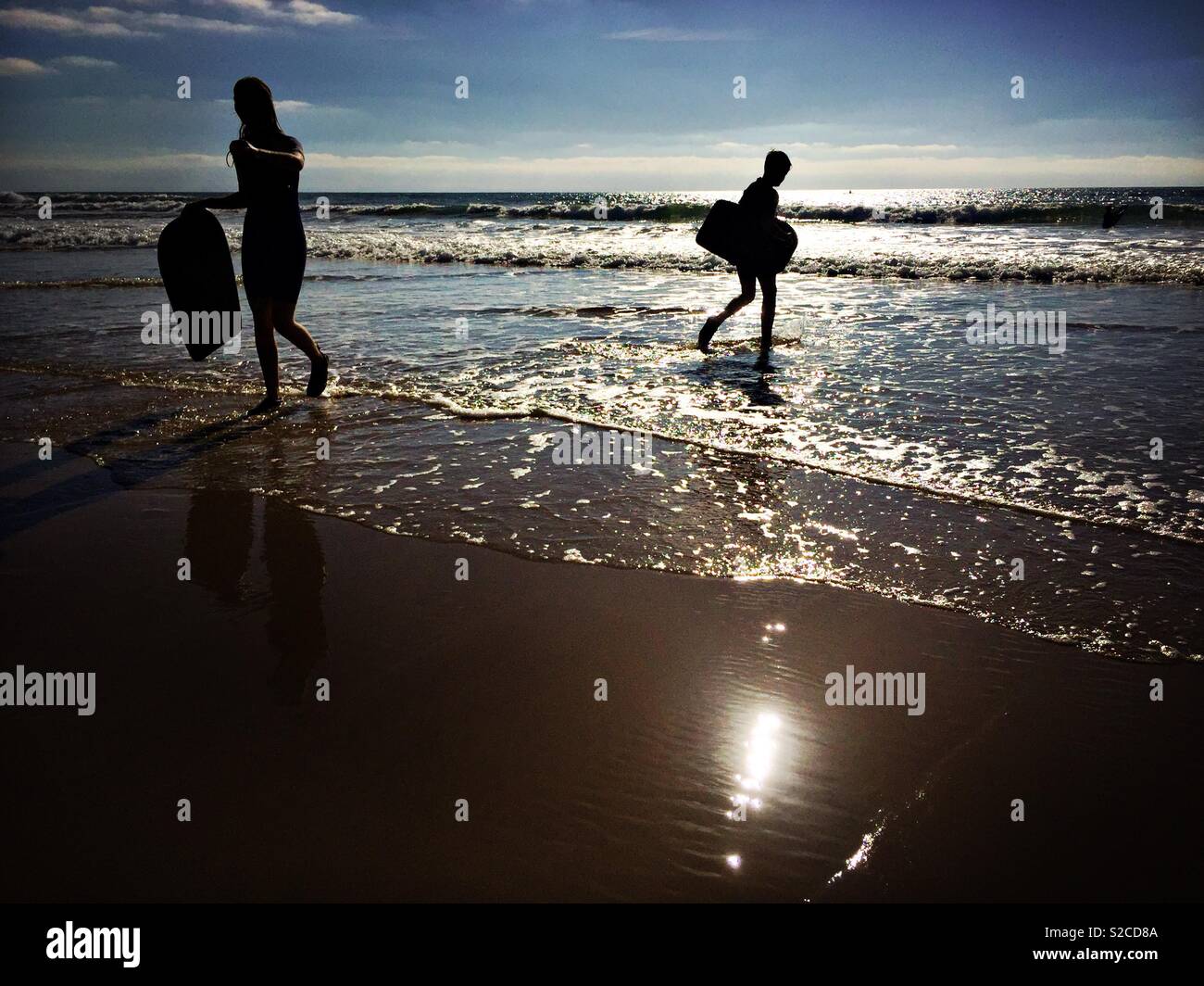 Kids walk out of the surf after body boarding in the sea at Slade Bay ...