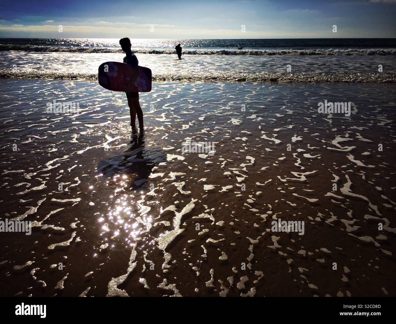 Kids walk out of the surf after body boarding in the sea during the ...
