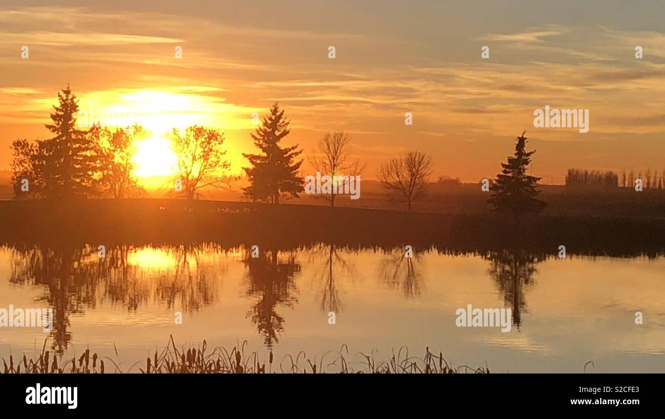 Sunset on water Stock Photo - Alamy