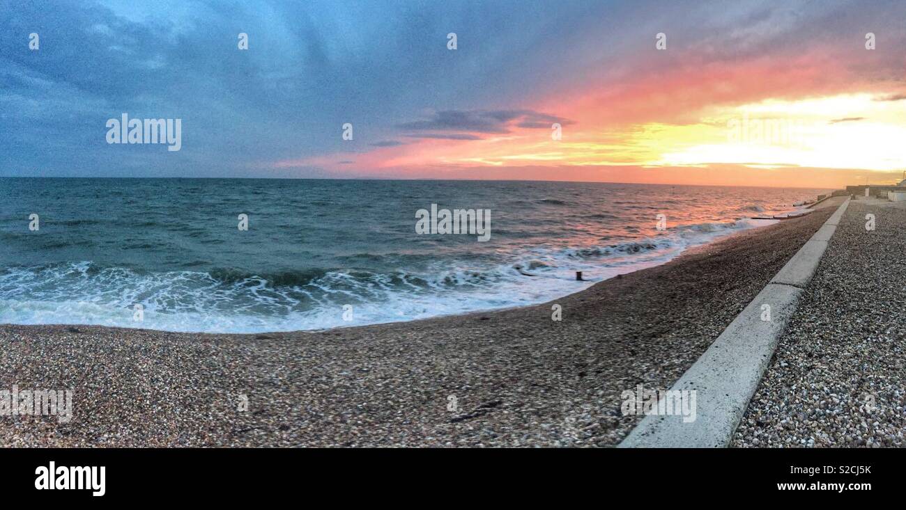 Sunset over uk beach Stock Photo - Alamy