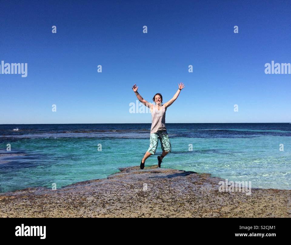 Jumping for joy at the beach Stock Photo - Alamy