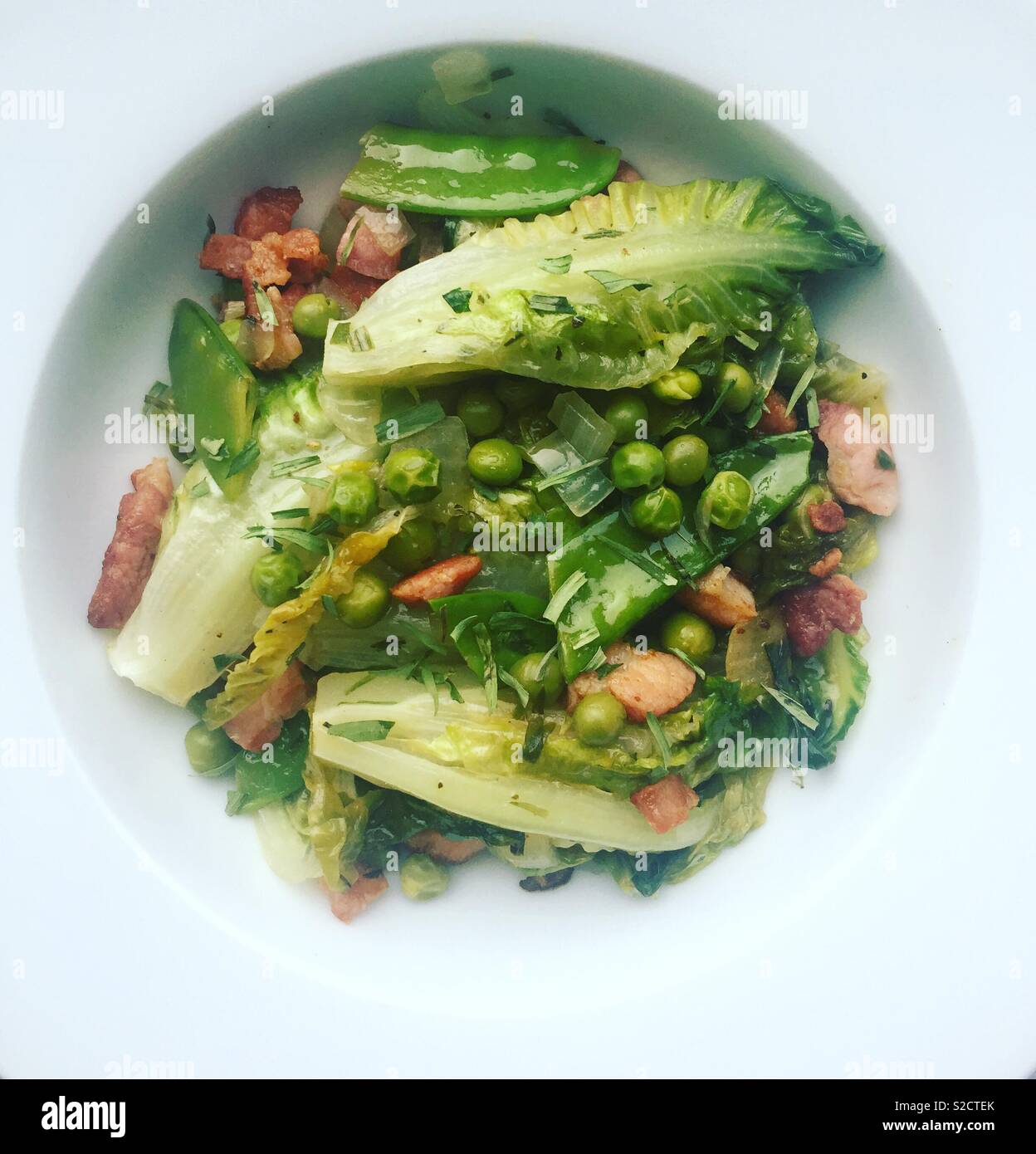 Braised lettuce with lardons and peas Stock Photo - Alamy