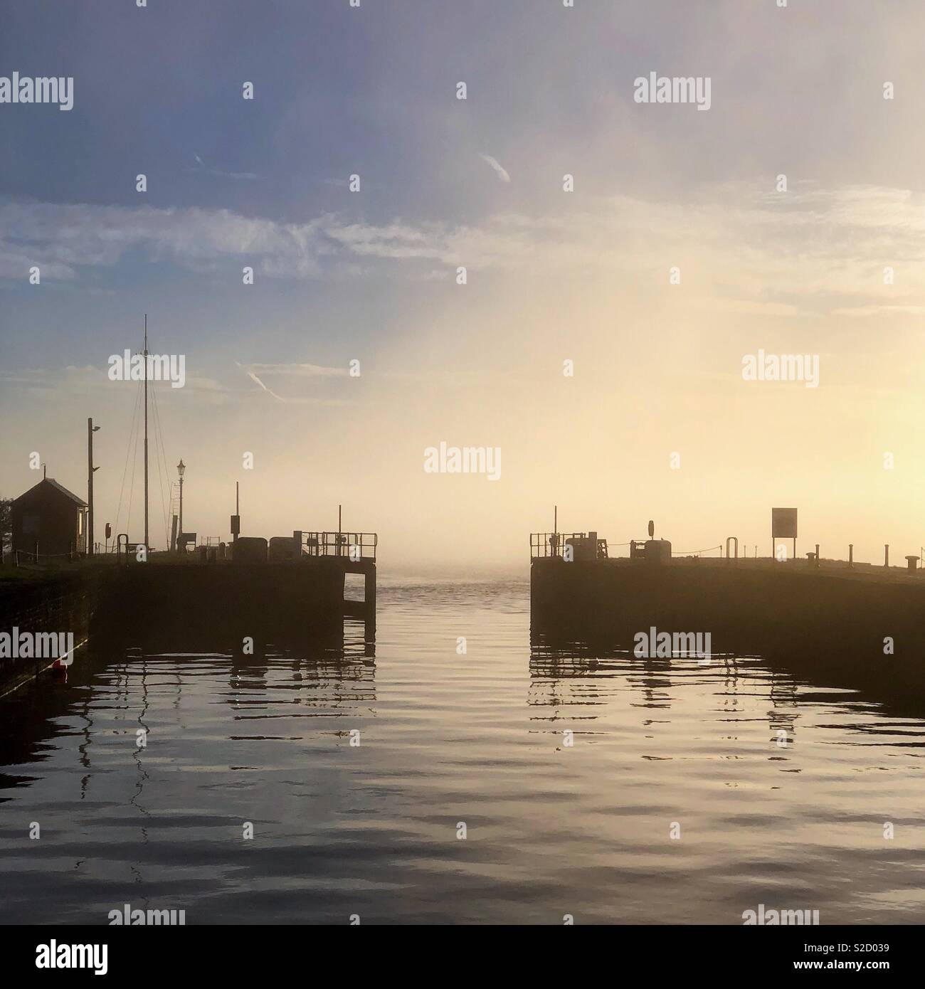 Docks in fog at sunrise Stock Photo - Alamy