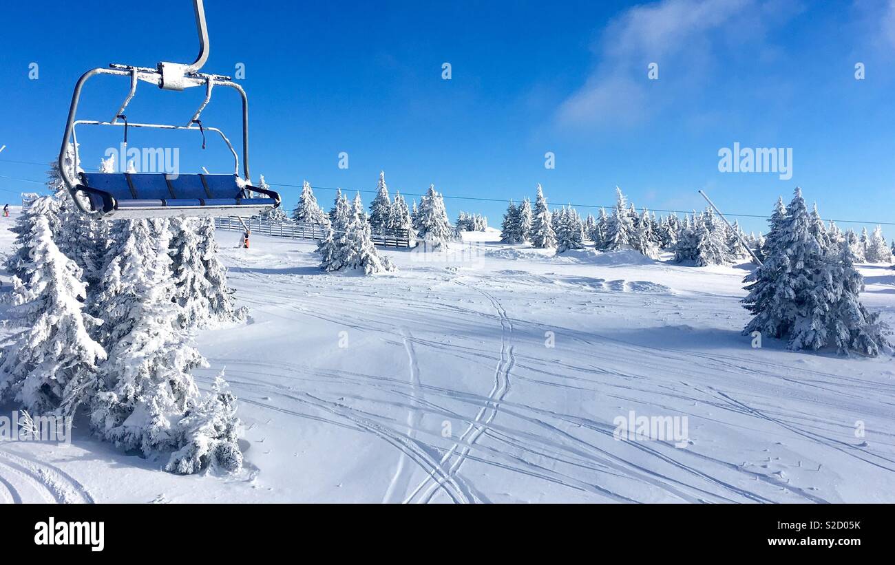 Winter landscape with empty ski lift chair surrounded by stunning ...