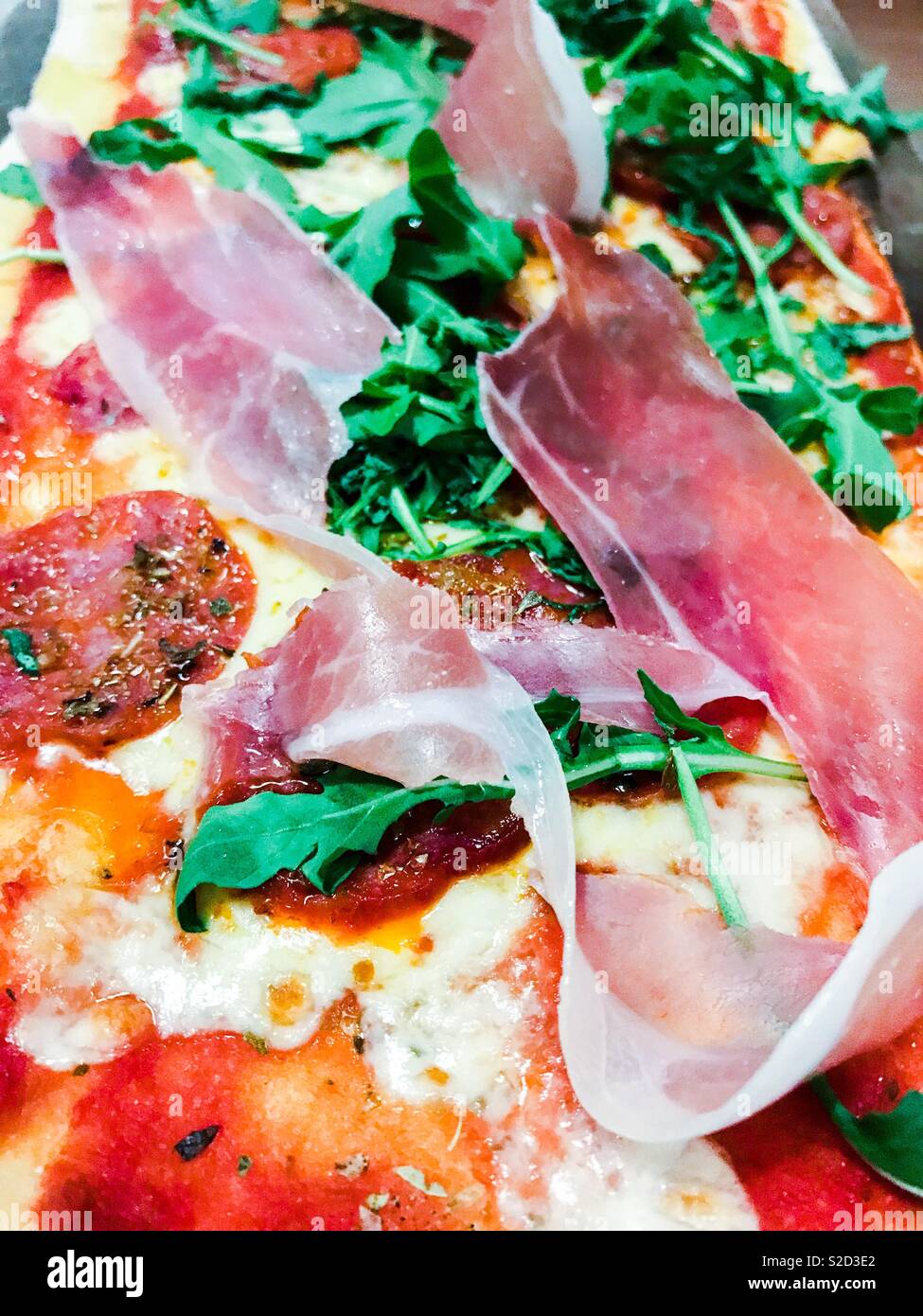 Closeup of pepperoni and ham pizza Stock Photo - Alamy