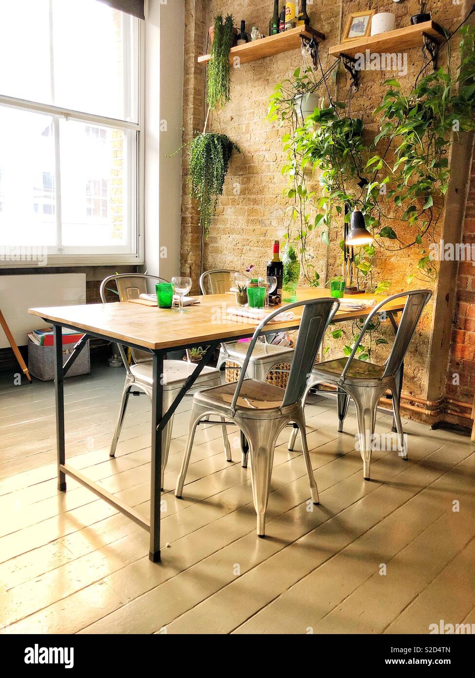 Sunday lunch table in industrial loft style apartment Stock Photo - Alamy