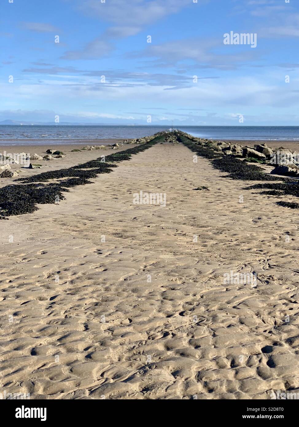 Pathway leading to a stone jetty on Portobello Beach in Edinburgh Stock ...