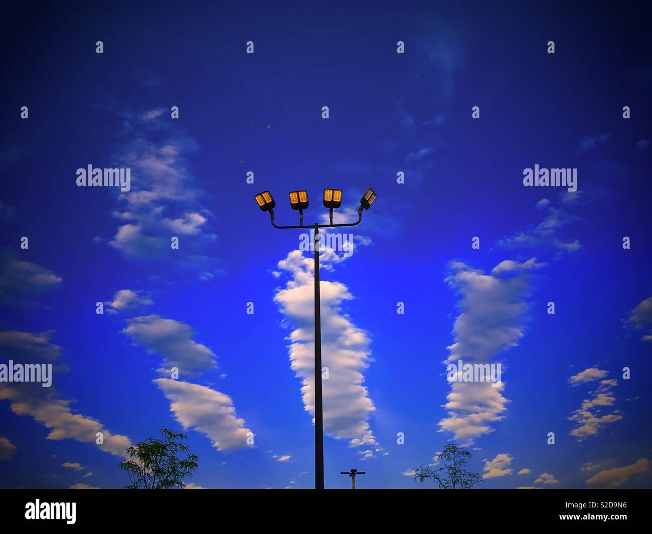 Lamp post and parallel clouds Stock Photo - Alamy