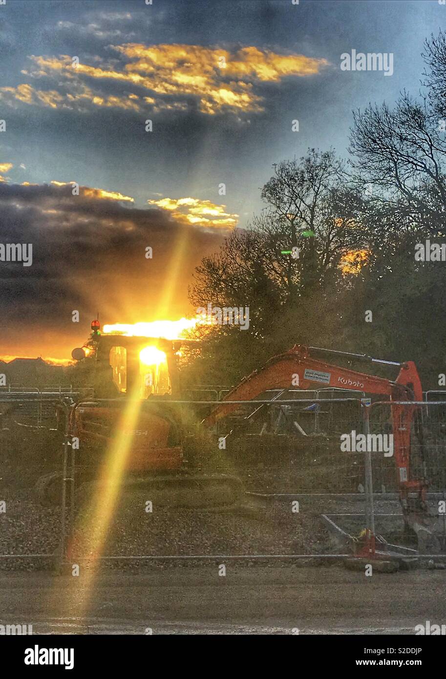Sun setting through a Digger machine Stock Photo - Alamy