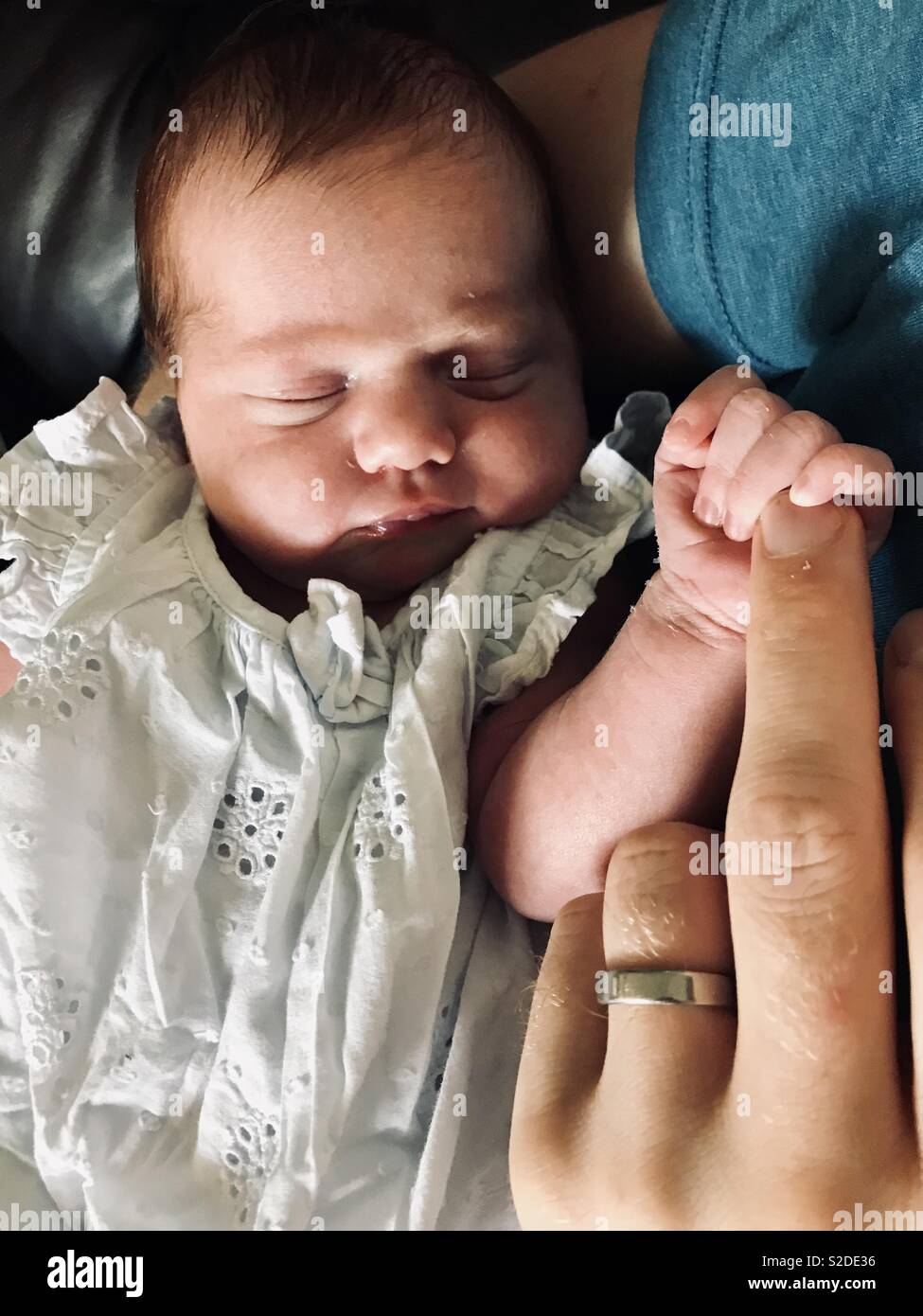 Baby holding finger hi-res stock photography and images - Alamy