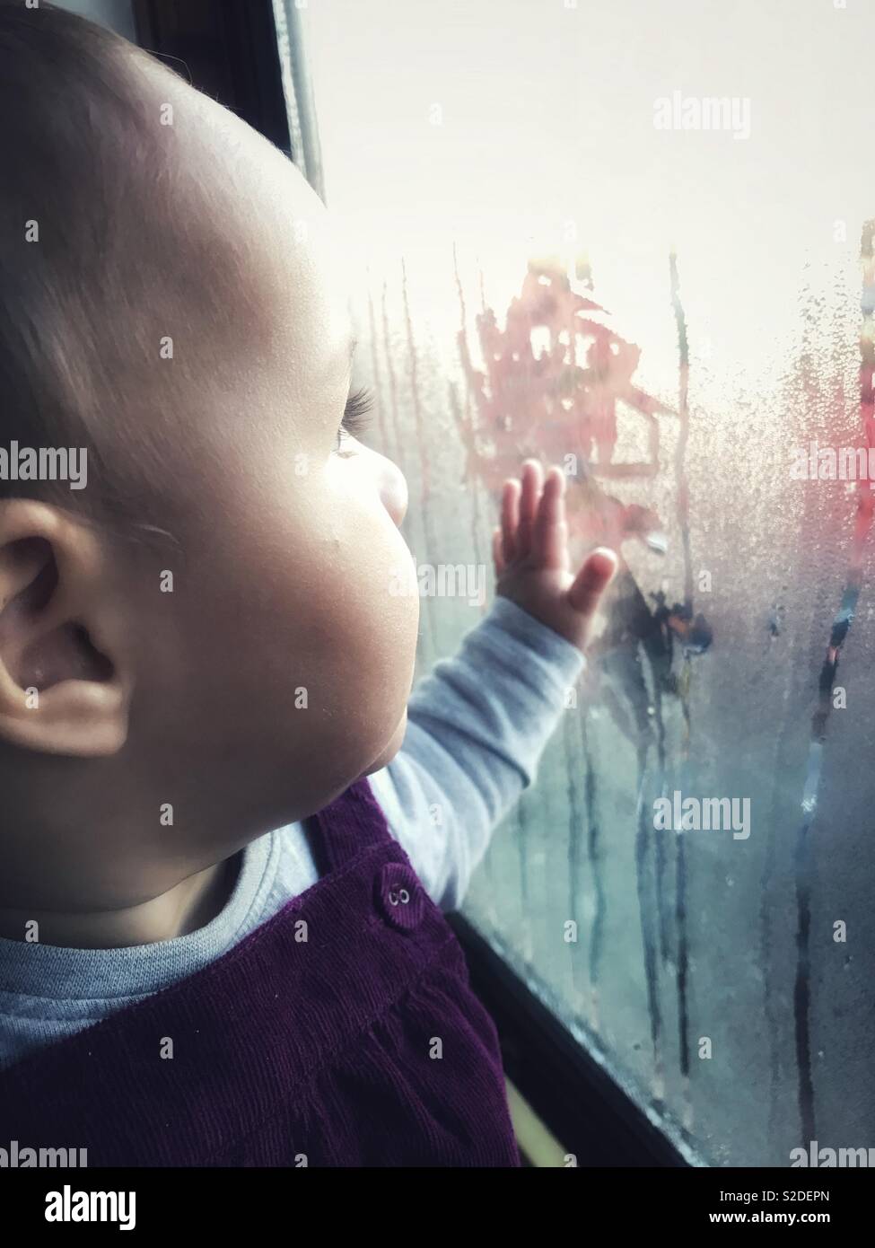 Baby at winter window Stock Photo - Alamy