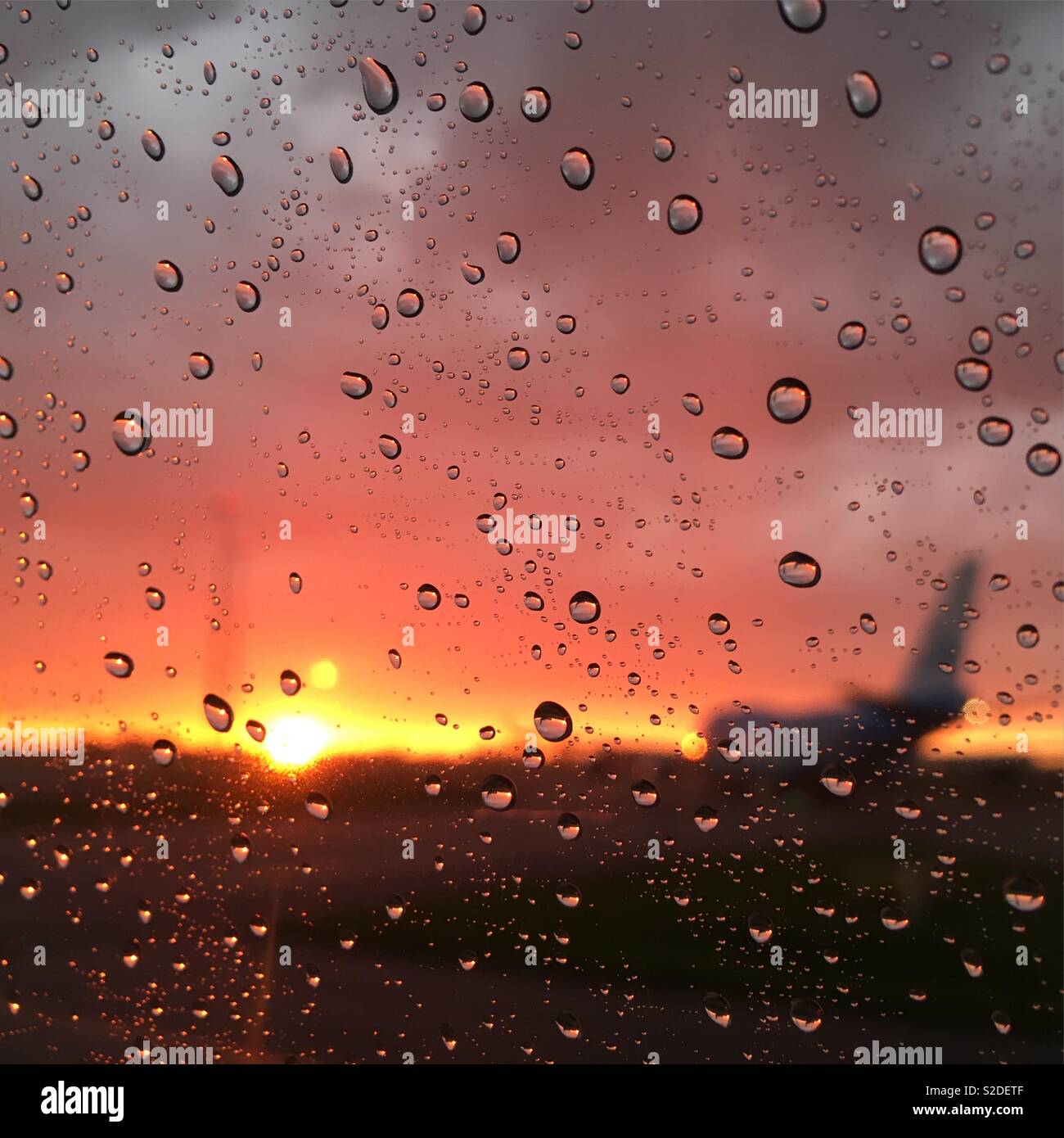 Sunset through window after the rain at the airport Stock Photo - Alamy