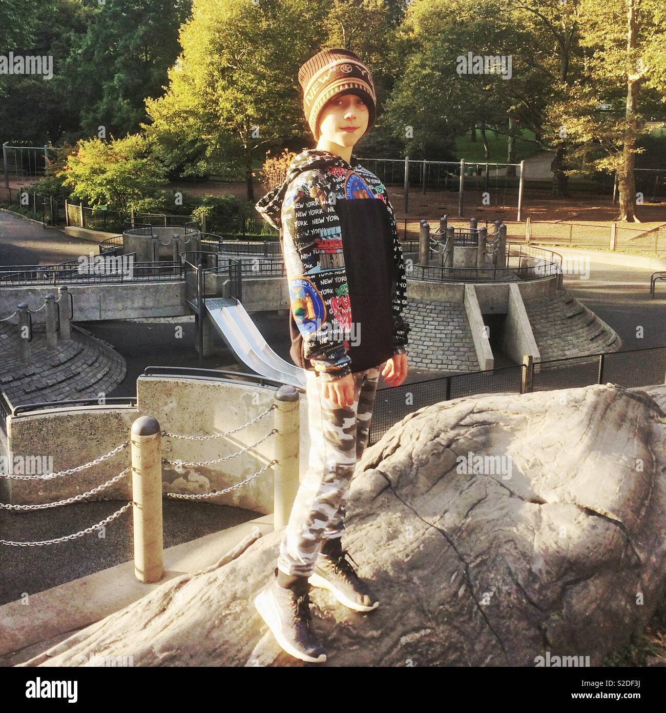 Nine year old boy on the rocks at Central Park, New York City, United ...