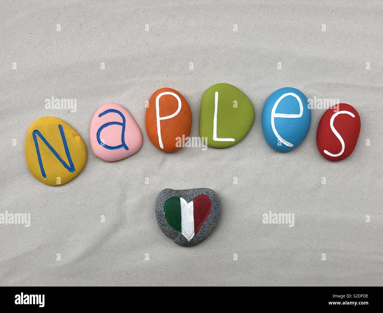 Naples, Italy, souvenir with colored stones over white sand Stock Photo ...