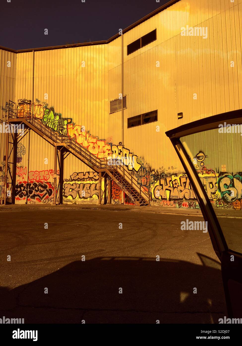 The factory building on graffiti before the sunset with my car driver’s ...