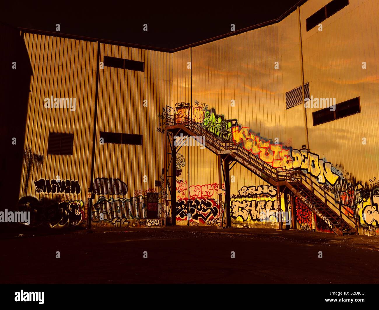 The factory building on graffiti before the sunset Stock Photo - Alamy