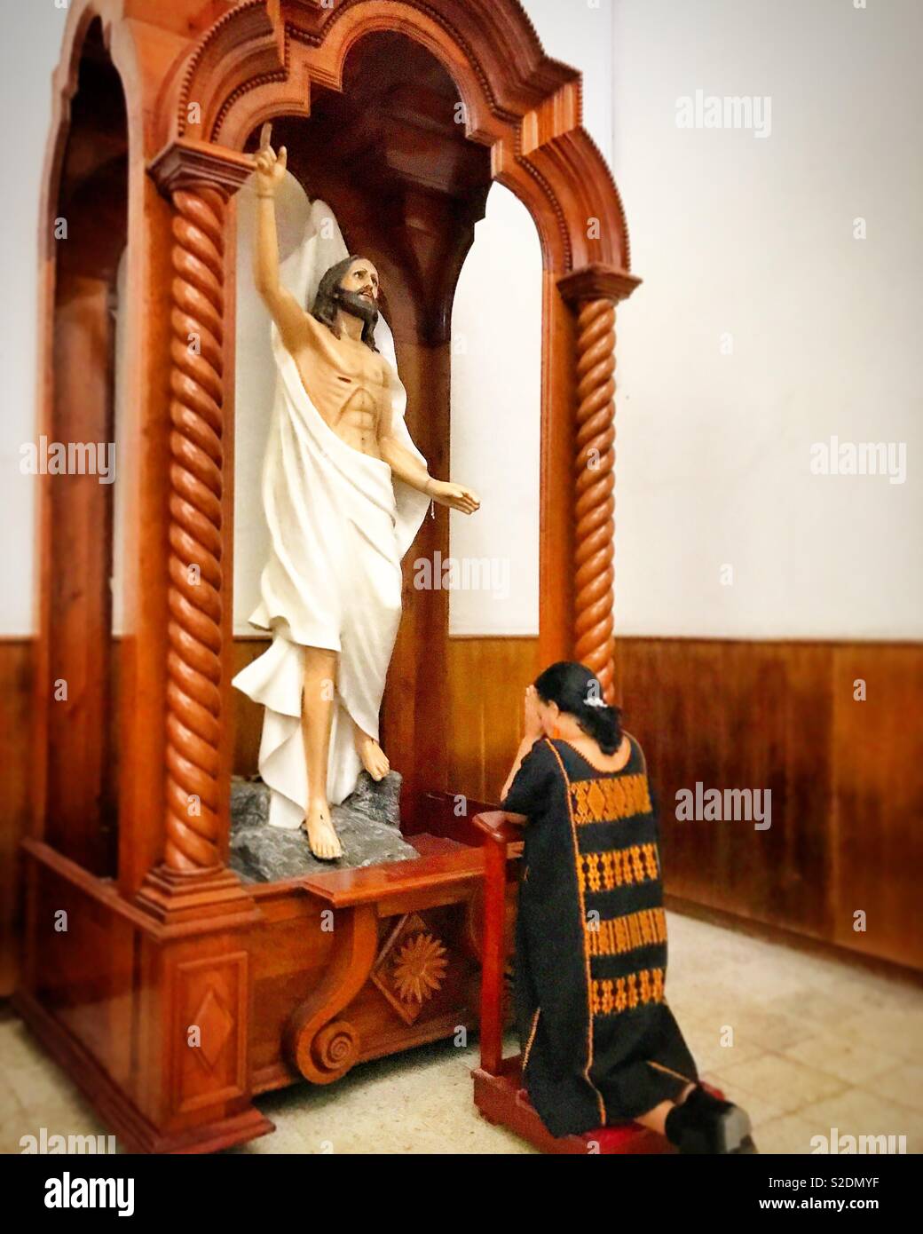 A woman dressed as an indigenous “mixe” indigenous ethnic group prays ...