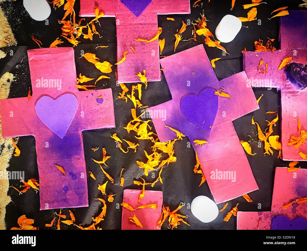Pink roses decorated with hearts decorate an altar during Day of the ...
