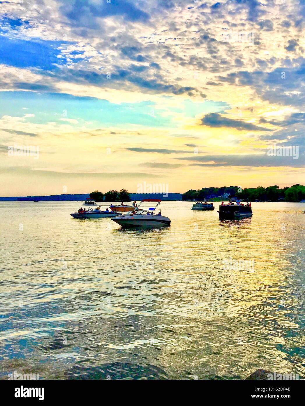 Boats on Pewaukee Lake at twilight Stock Photo - Alamy