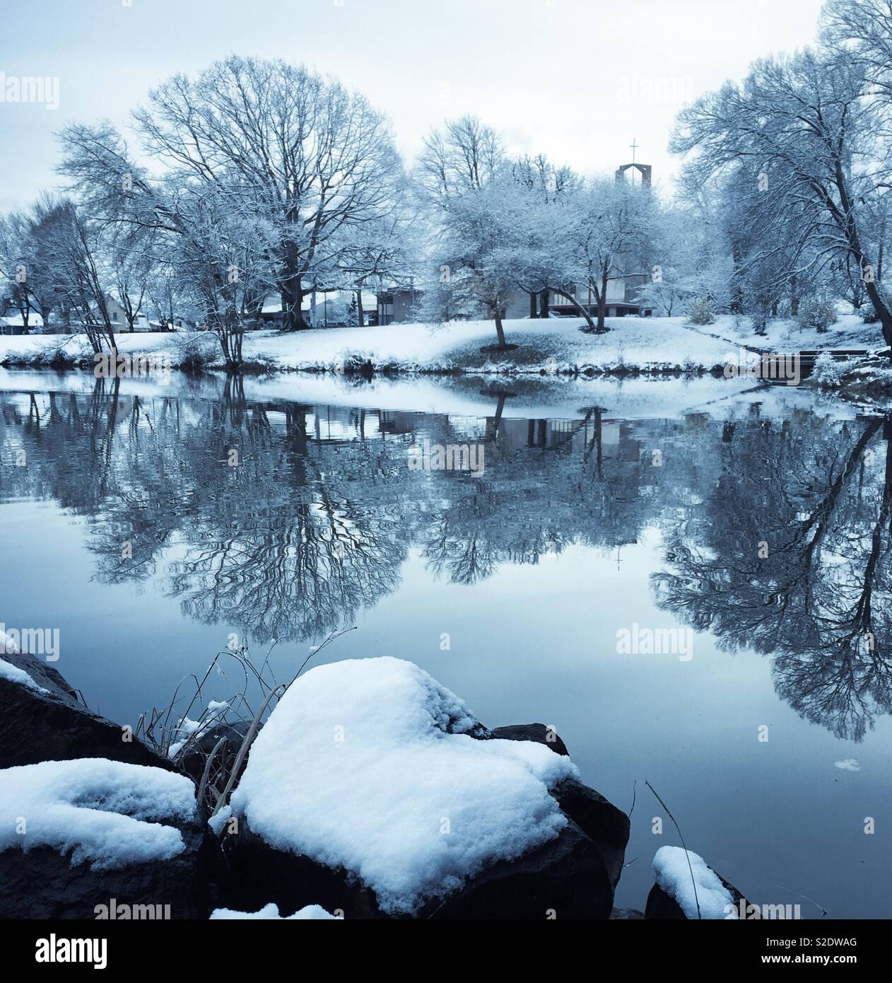 Winter Scene with Snow on Trees Reflecting on a Lake Stock Photo - Alamy