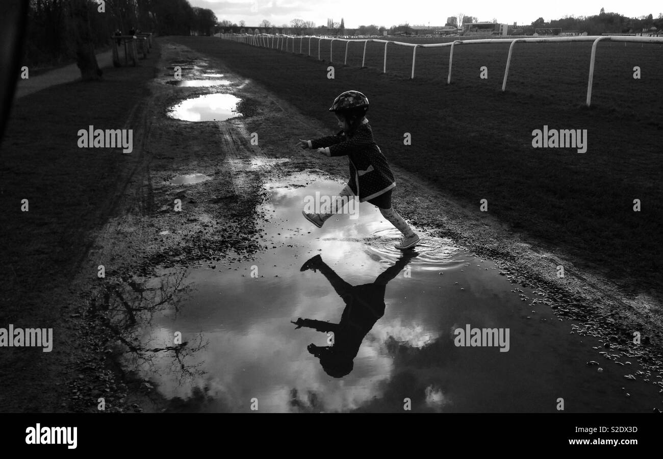 Puddle jumping reflections Stock Photo - Alamy