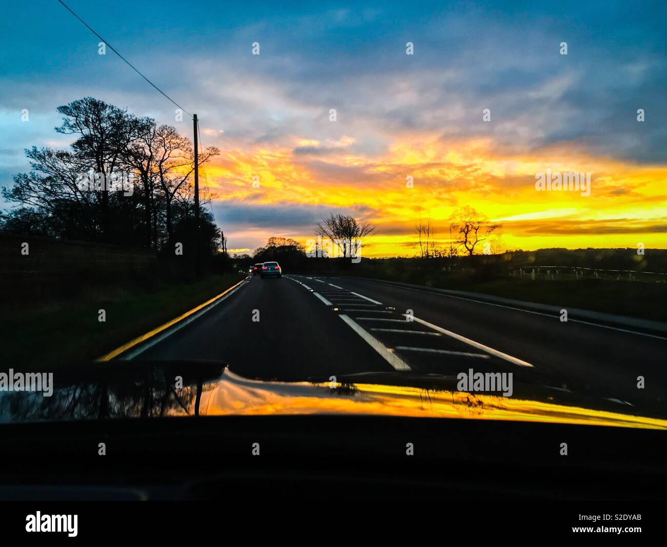 View from a BMW M4 cockpit driving on road with vivid sunset Stock ...