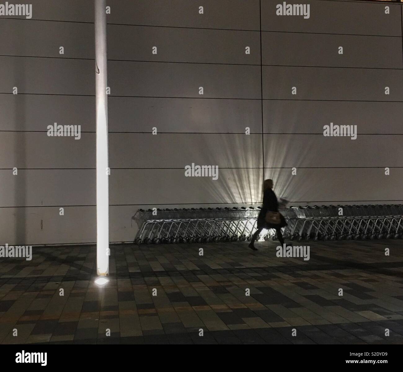 Woman Walking Past Wall Shadow Stock Photos & Woman Walking Past Wall ...