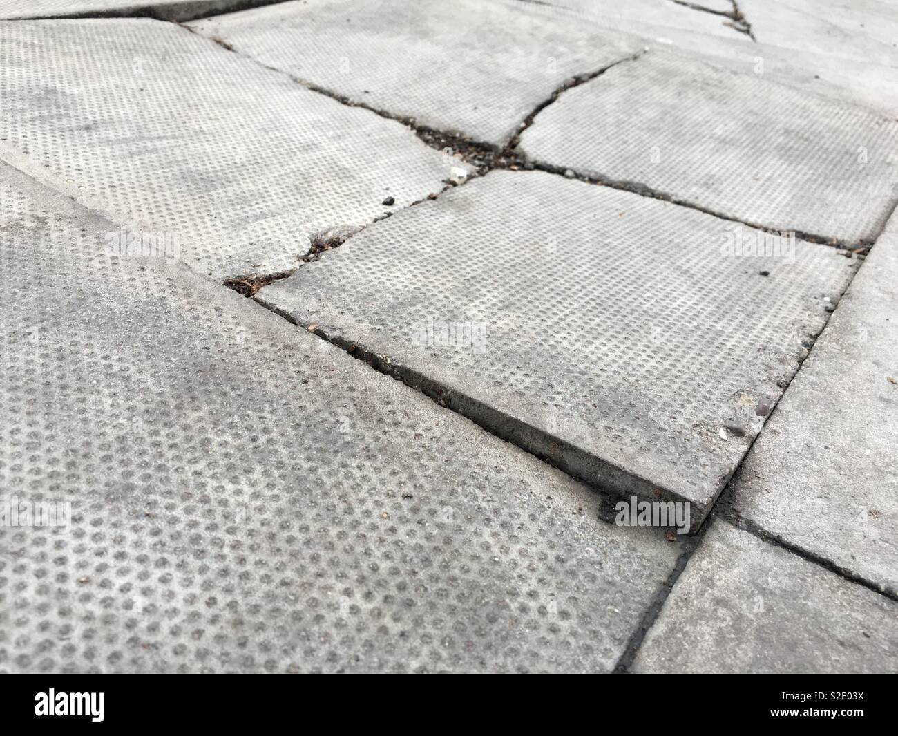 Broken slabs are a trip hazard often caused when goods vehicles mount ...