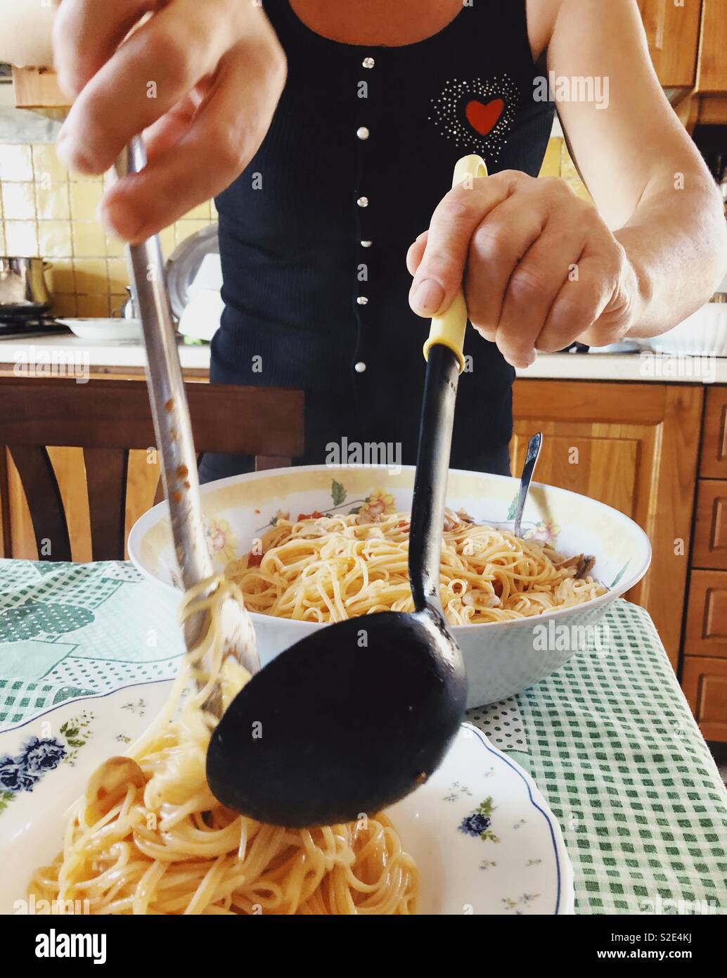 Italian woman serving pasta Stock Photo - Alamy