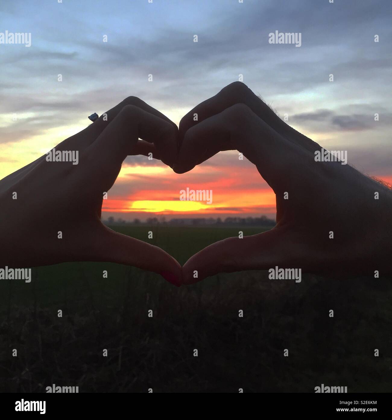 A couple making a heart shape with their hands hi-res stock photography ...