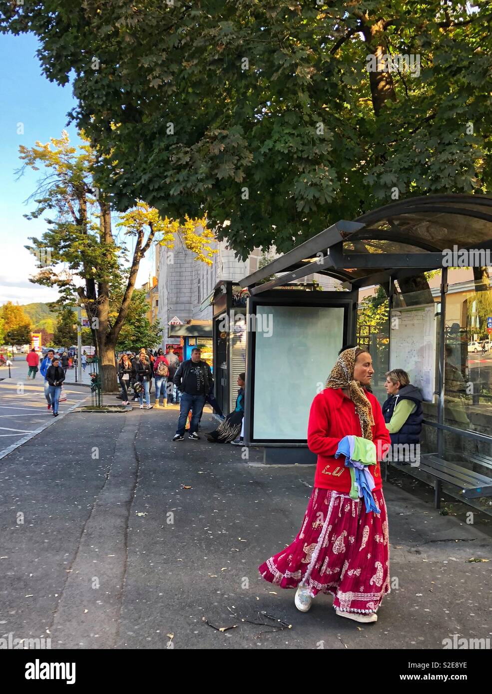 A Roma gypsy woman walking on a street in Brasov, Romania Stock Photo ...
