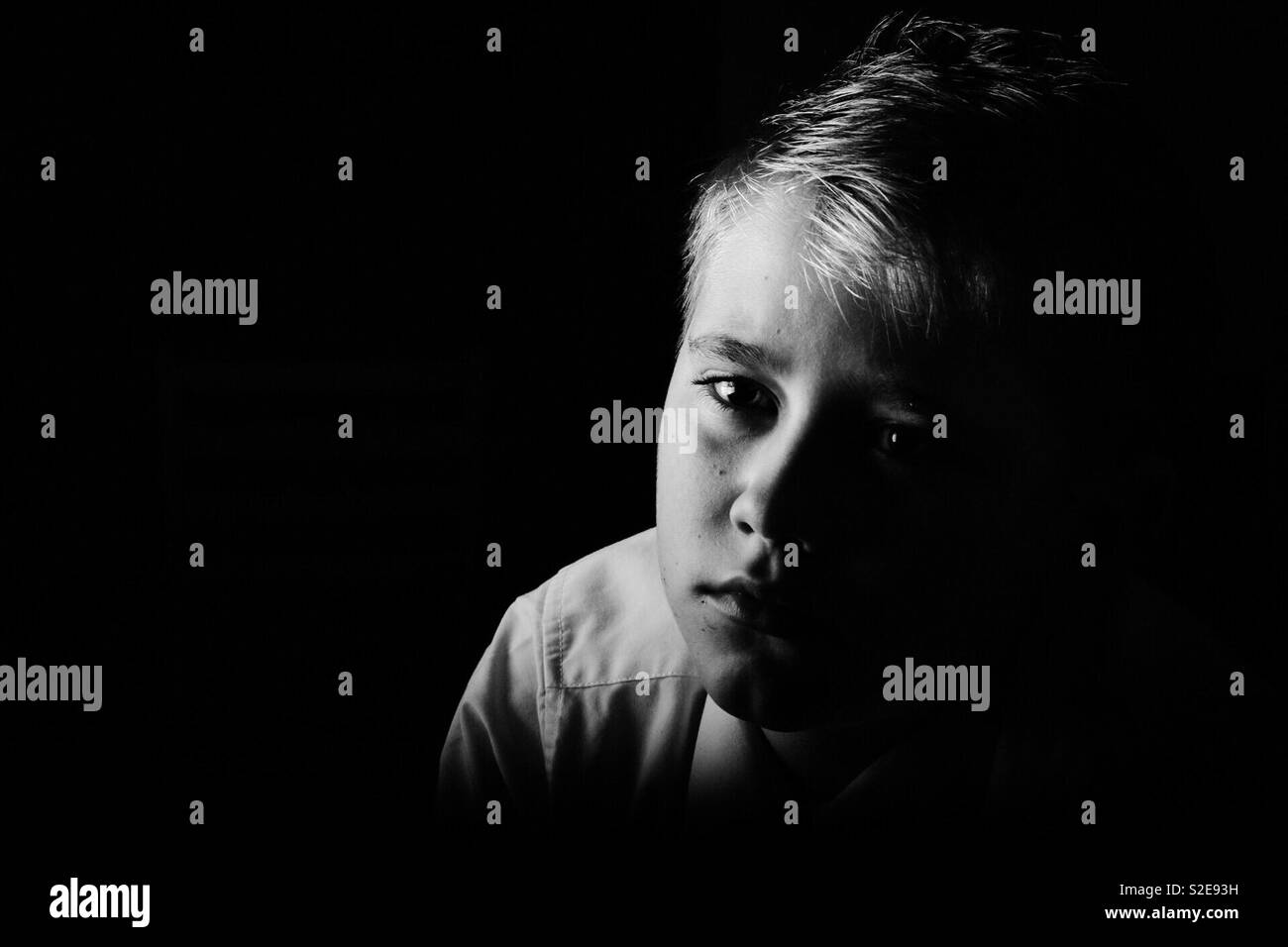 Low key portrait of boy Stock Photo - Alamy