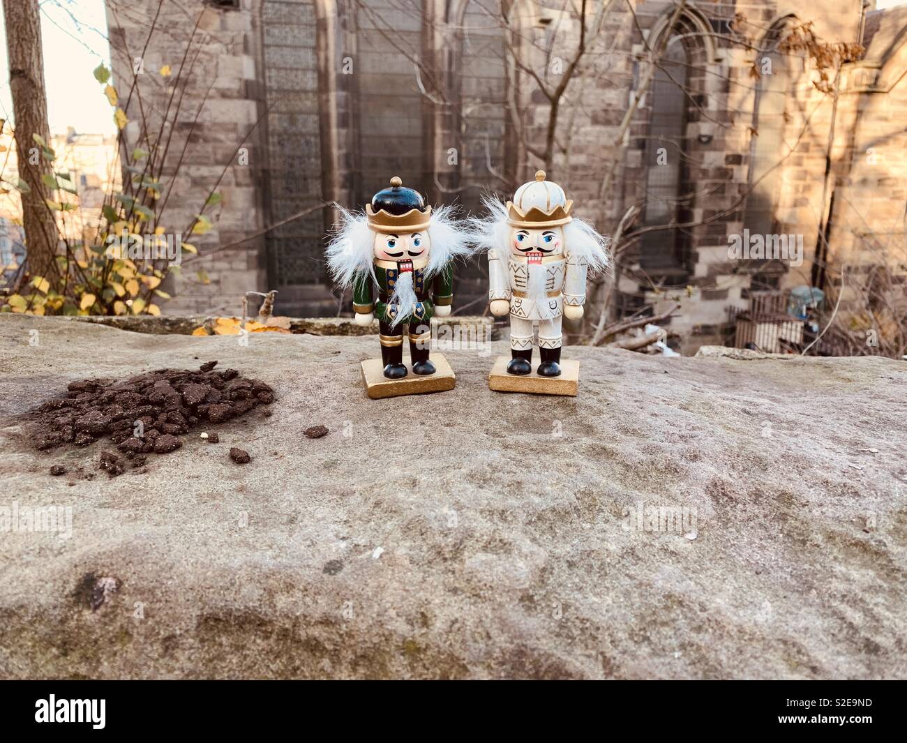 Two small nutcrackers standing on a church wall Stock Photo - Alamy