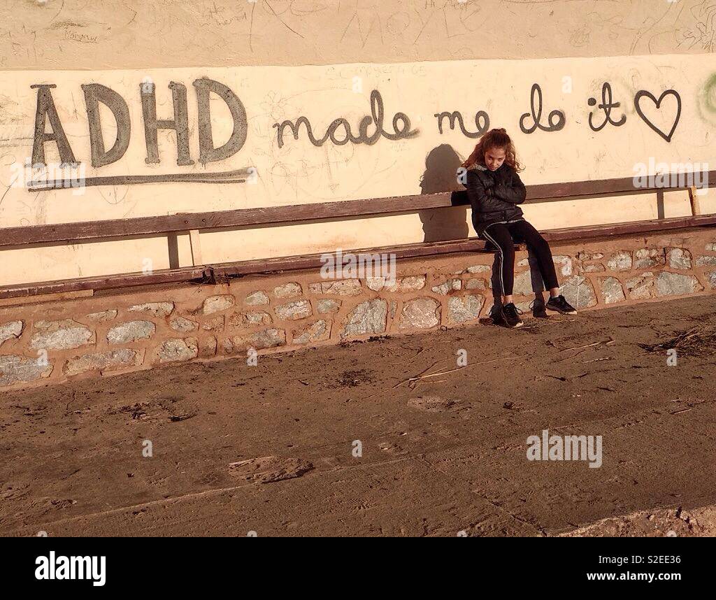 ADHD child behavioural issues. Ten year old girl in front of graffiti ...