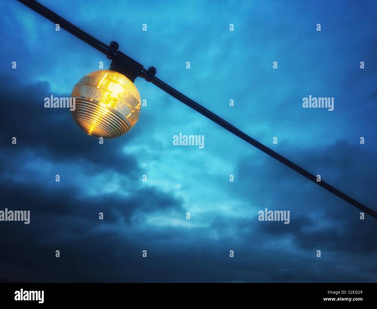 Light bulb against an evening sky, November Stock Photo - Alamy