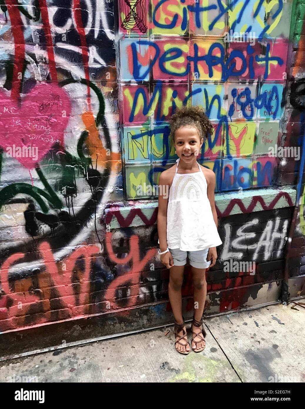 Little girl against graffiti Stock Photo - Alamy