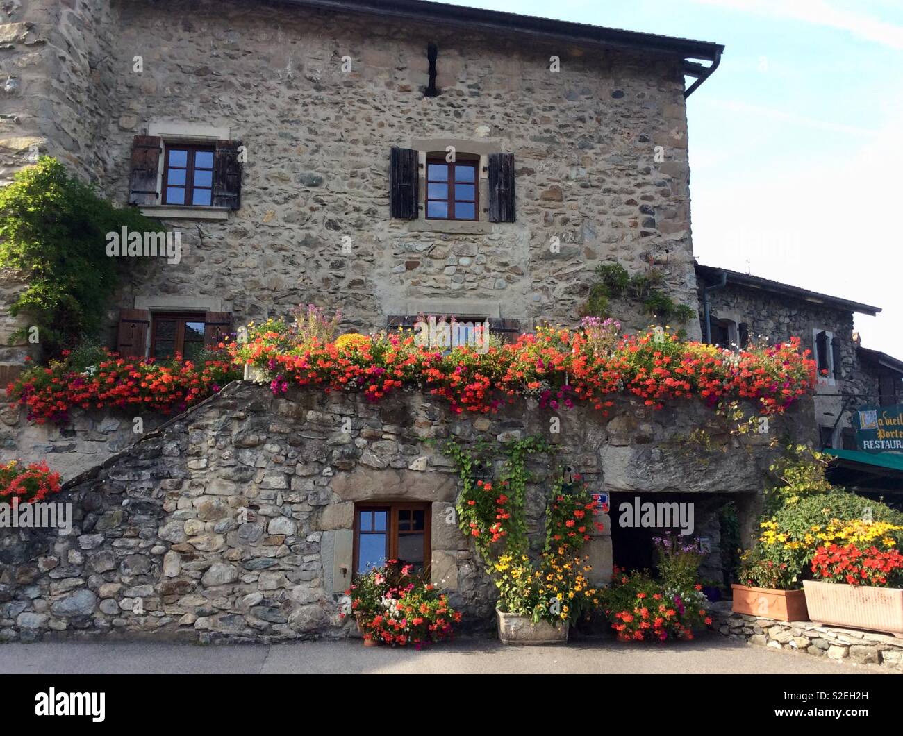Floral display at the front of a French rural building in Yviore ...