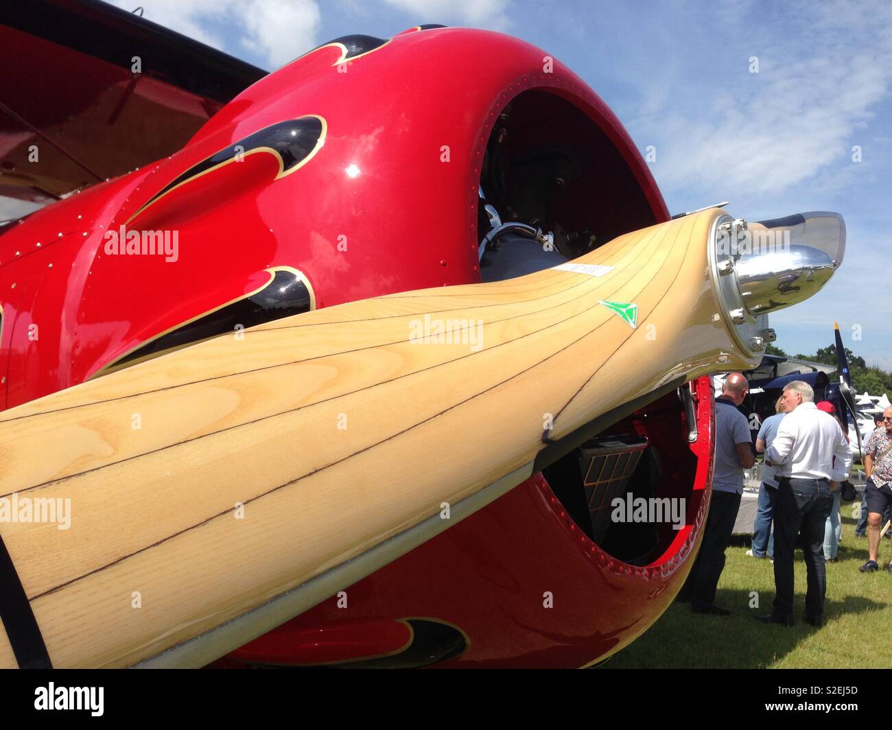 Wood and chrome propeller of red stunt plane Stock Photo - Alamy