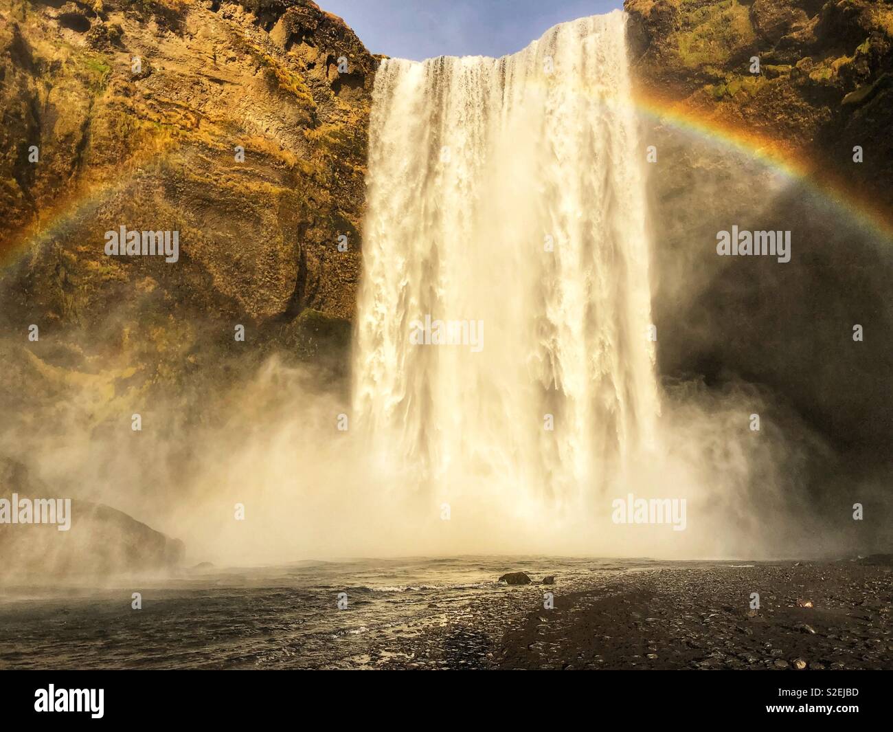 Rainbow over waterfall in Iceland Stock Photo - Alamy