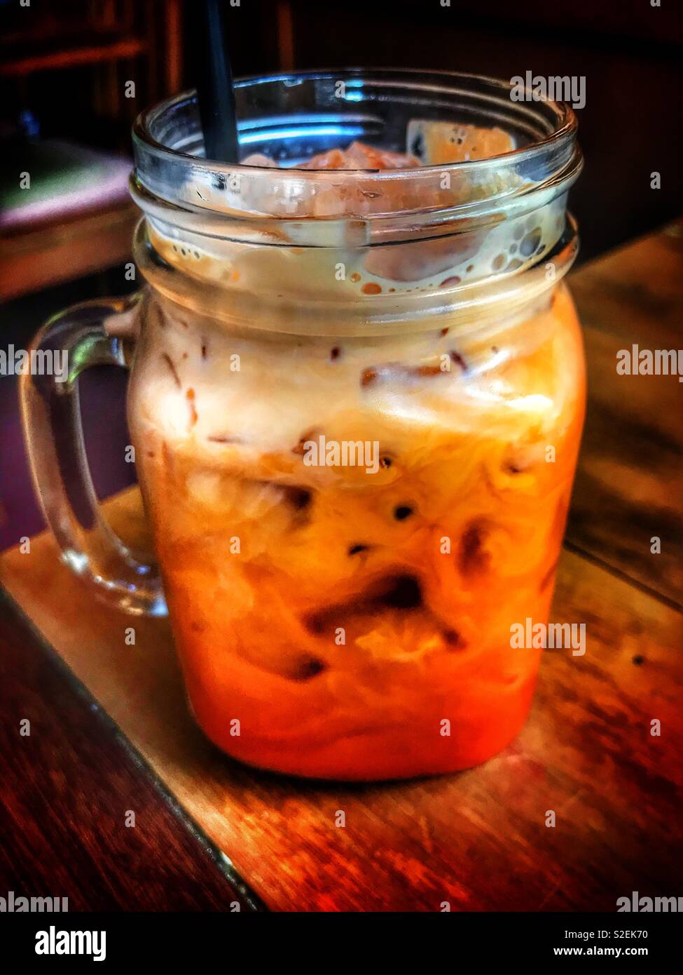 Thai iced tea in old mason jar glass Stock Photo - Alamy