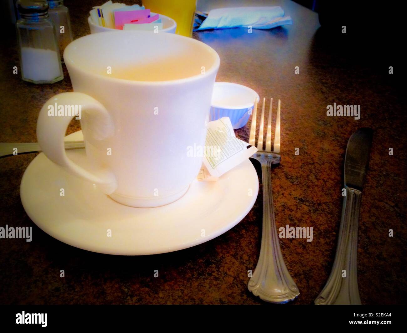 White coffee cup on diner table with Stevia packets Stock Photo - Alamy
