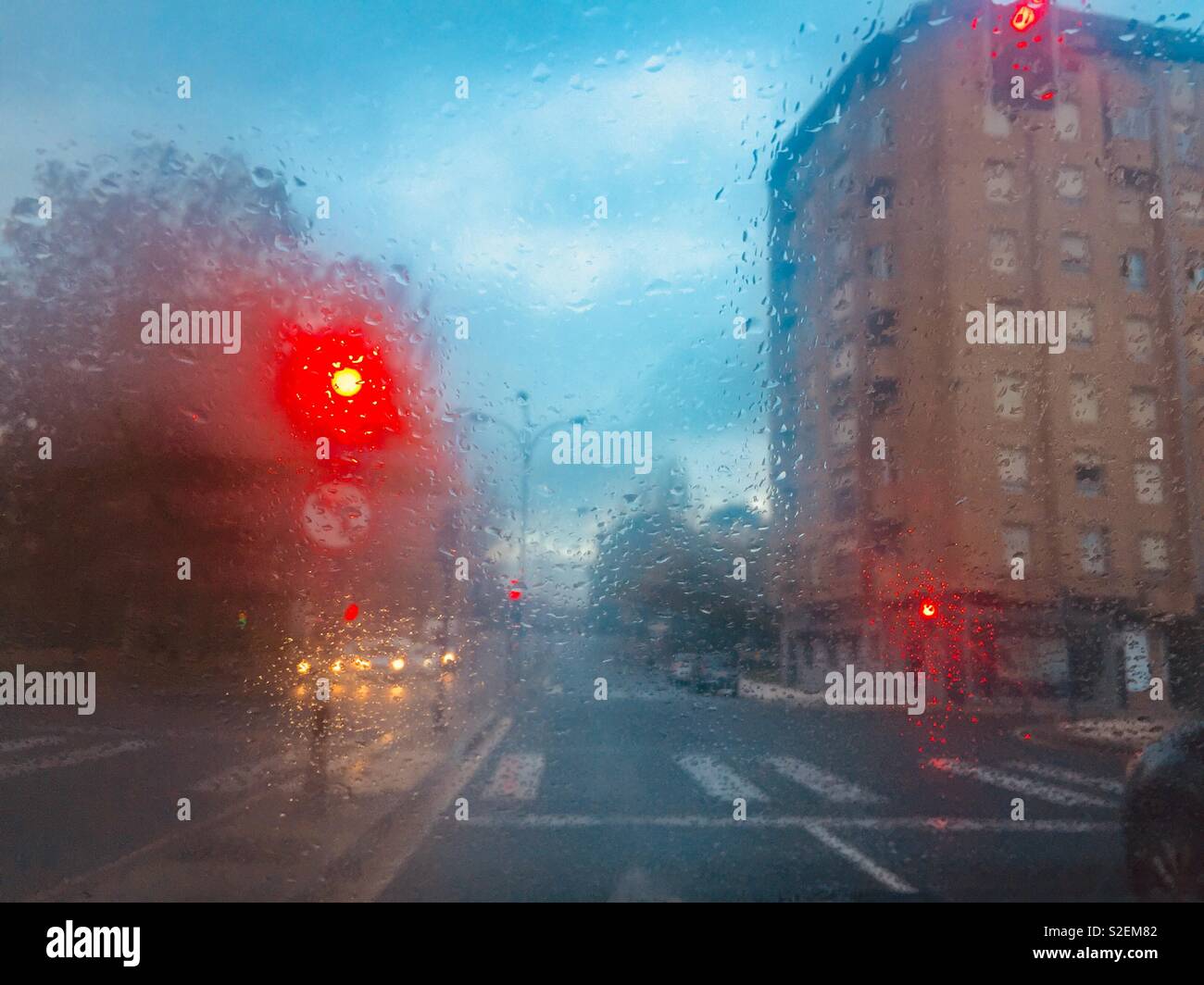 traffic light in red on rainy day from a car Stock Photo - Alamy