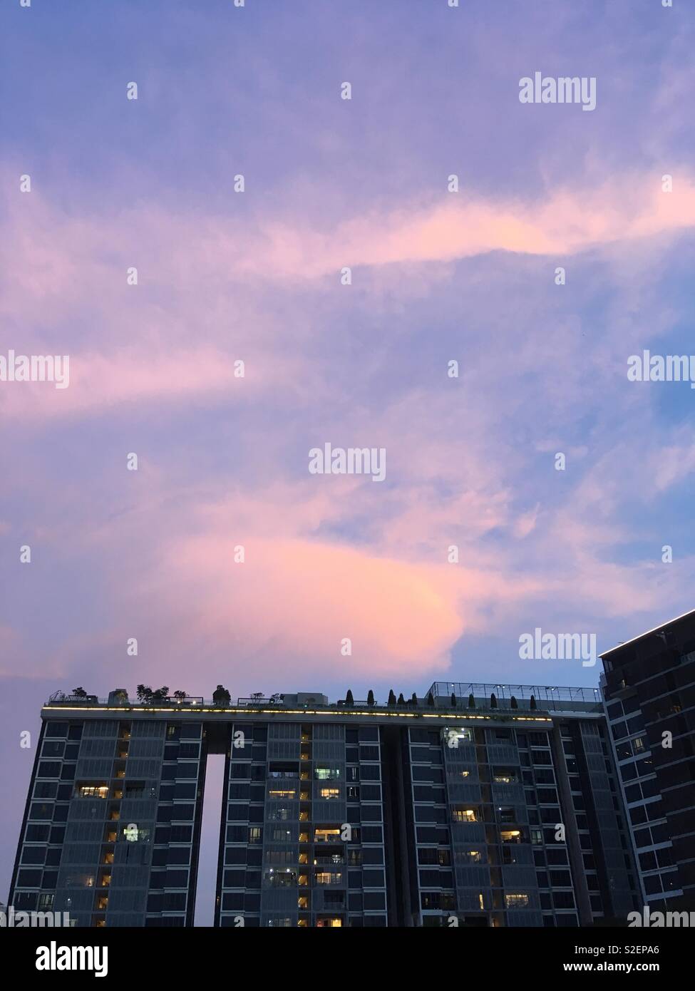 Pastel colour sunset sky above high rise building Stock Photo - Alamy