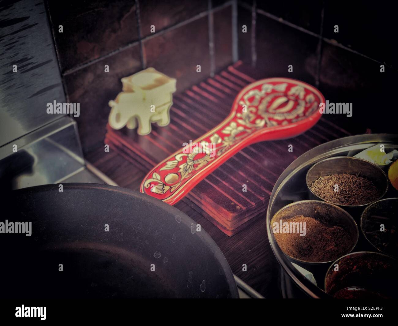 Round container for Indian spices next to shallow pan and rustic Indian ...