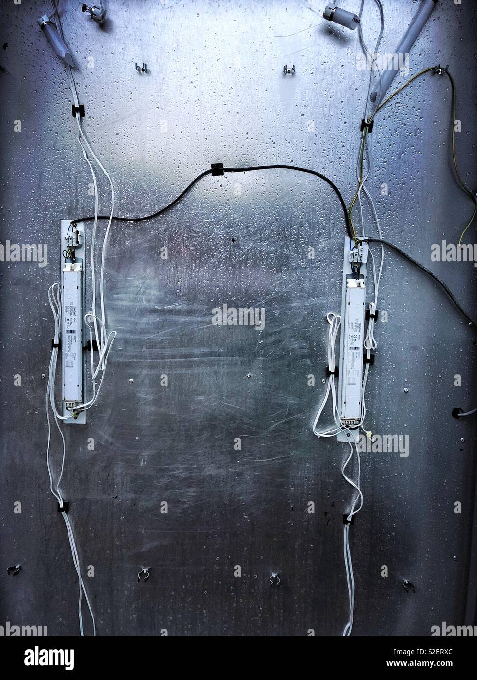 Side view of a damaged bus shelter showing the exposed wiring ...