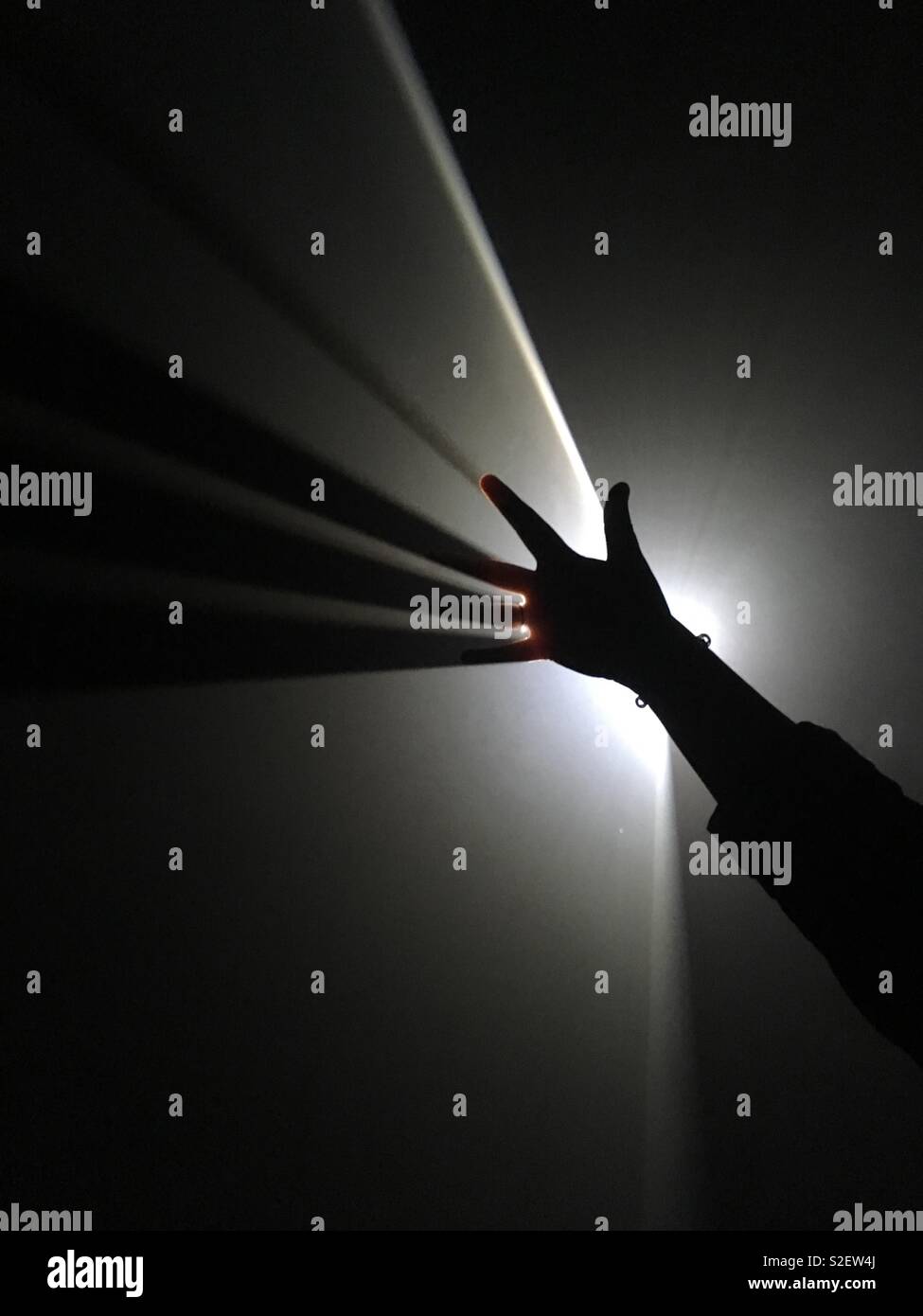 Hand in light projection Stock Photo - Alamy