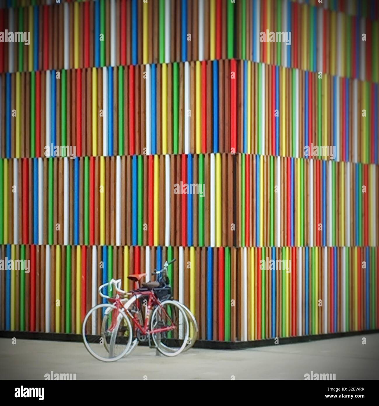 Bicycles by colourful office building Stock Photo - Alamy