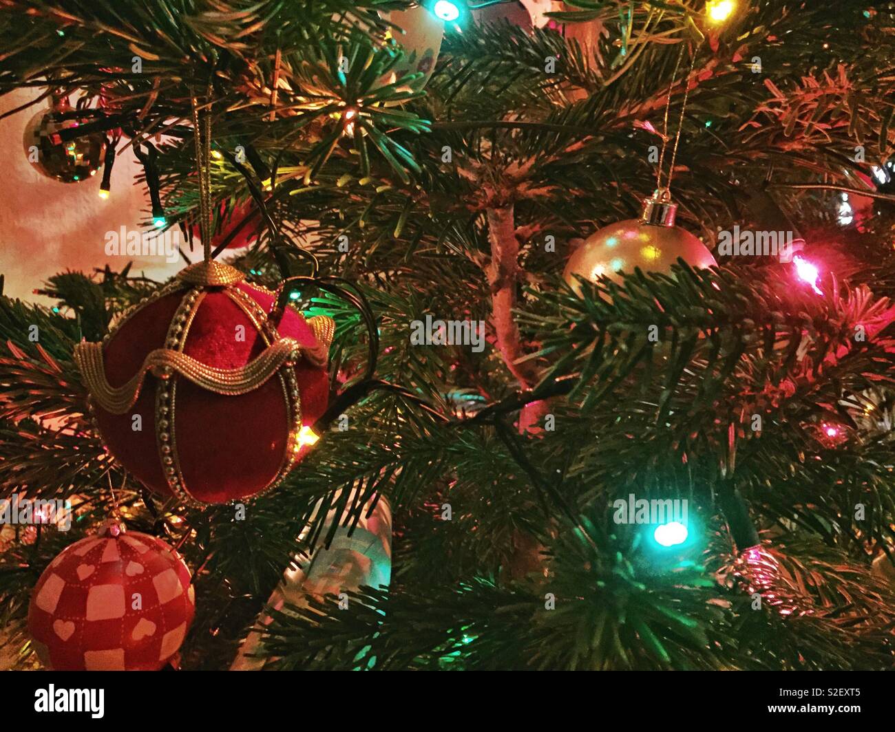 Baubles and fairy lights on a Christmas tree Stock Photo - Alamy